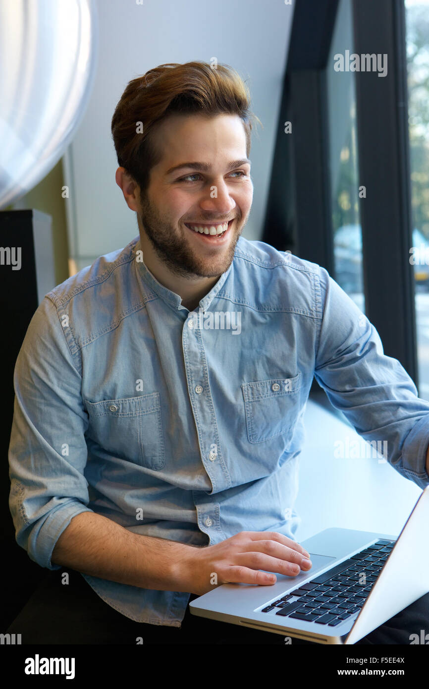 Portrait of a happy man working with laptop Stock Photo - Alamy