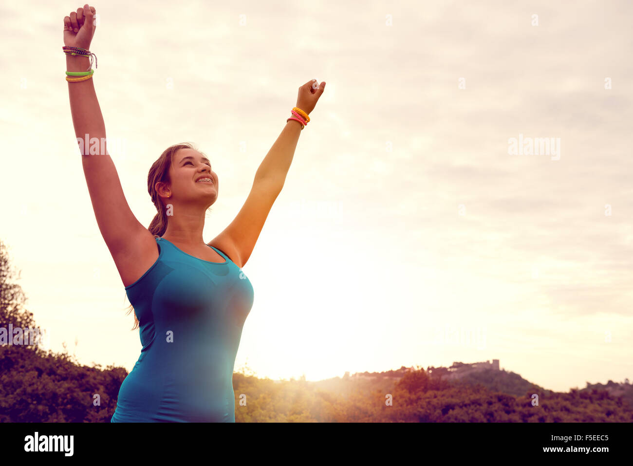 Happy girl jogging outdoors at sunset hour Stock Photo - Alamy