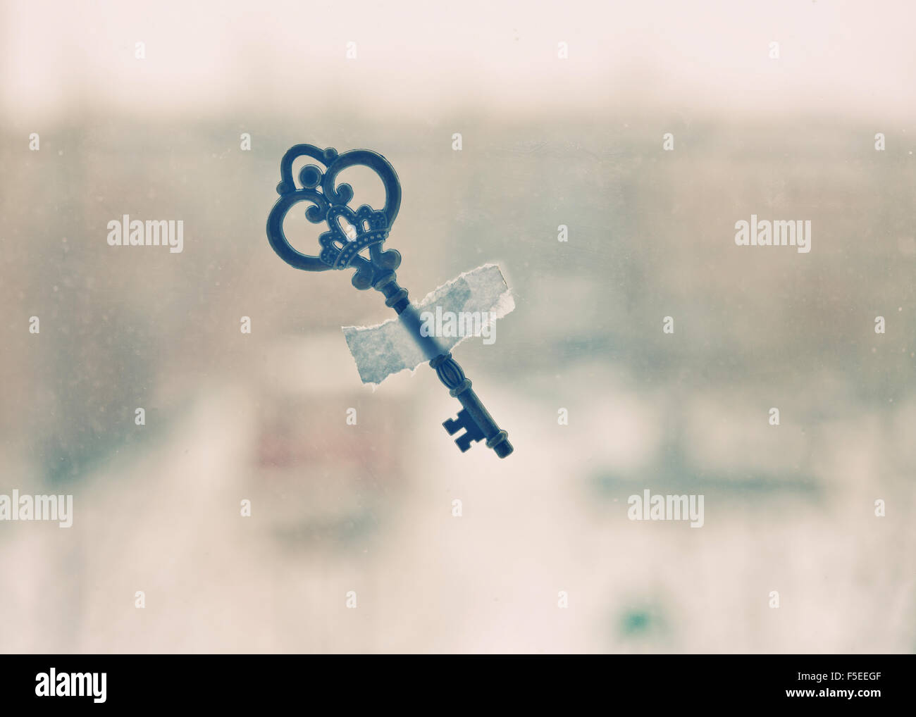 vintage key attached to window Stock Photo - Alamy