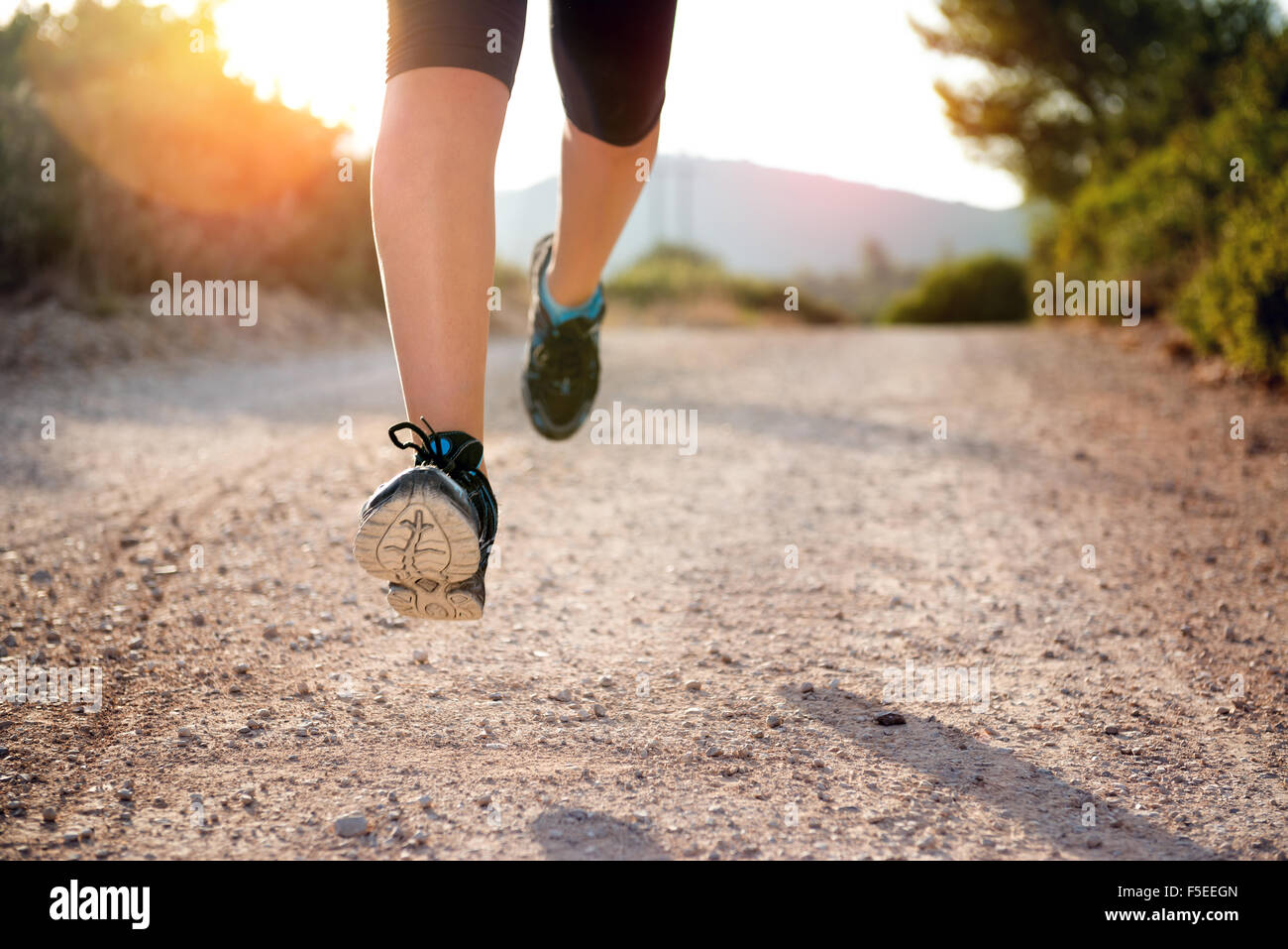Woman's legs running outdoors at sunset hour Stock Photo - Alamy