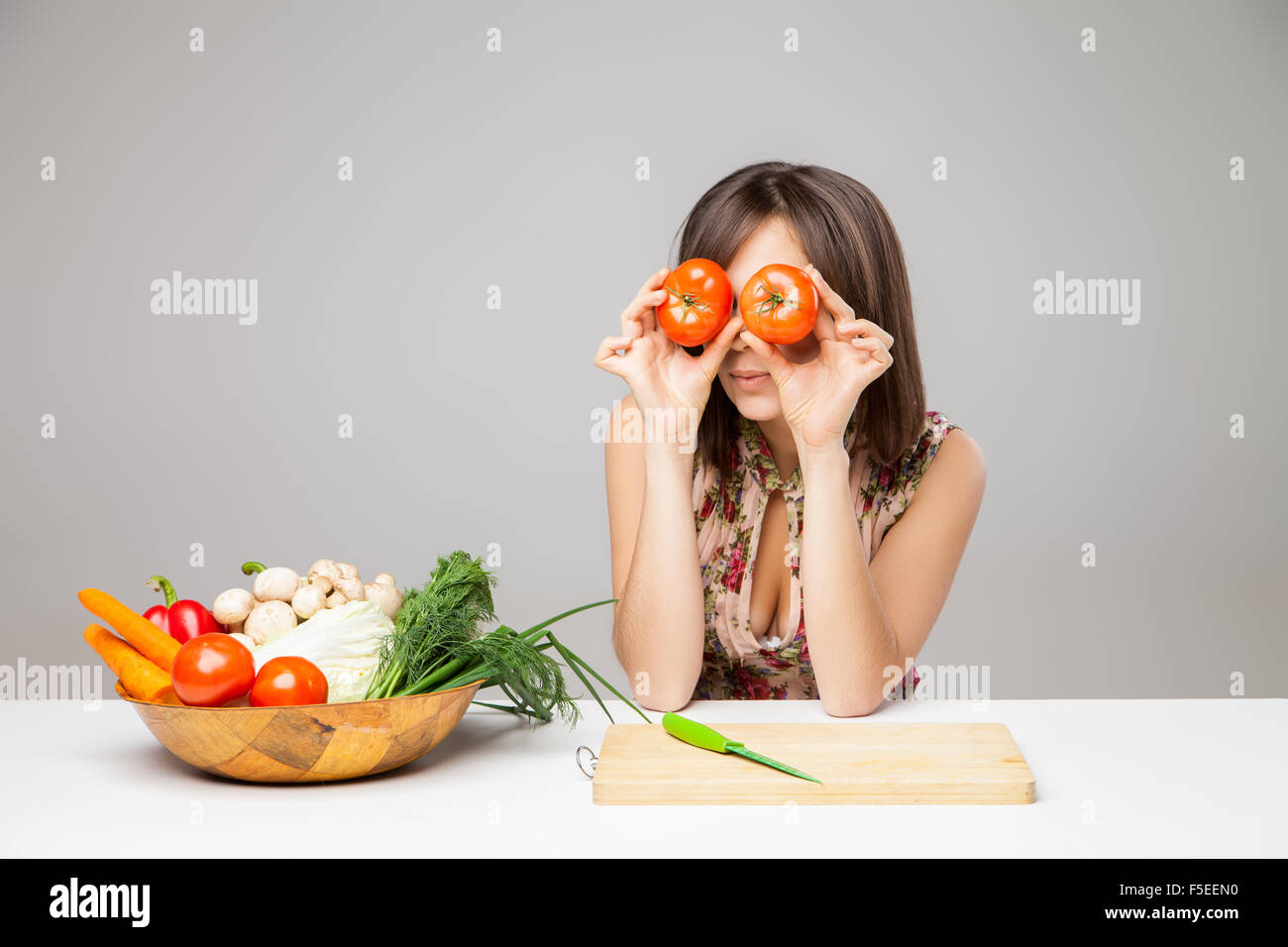 Happy girl with tomatoes look Stock Photo - Alamy