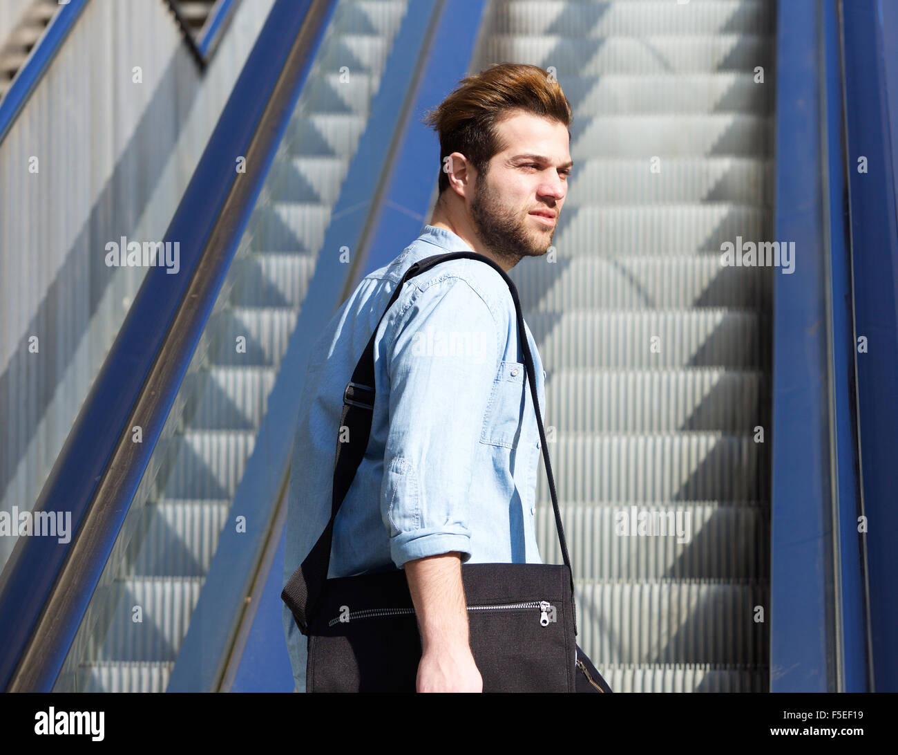 Portrait of a cool guy standing on escalator Stock Photo - Alamy