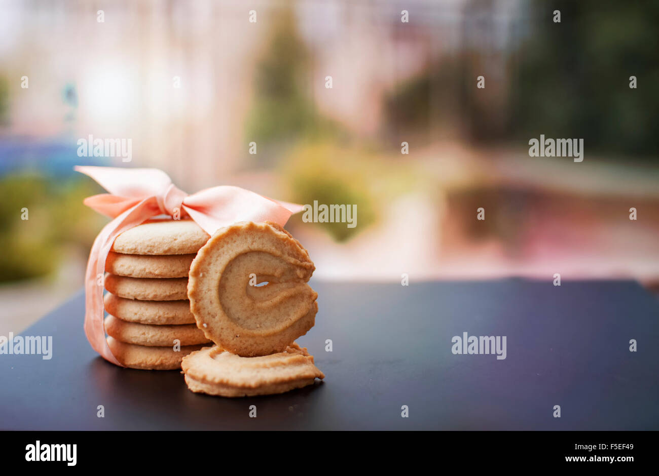 Stack of cookies on a table, wrapped in a ribbon Stock Photo - Alamy