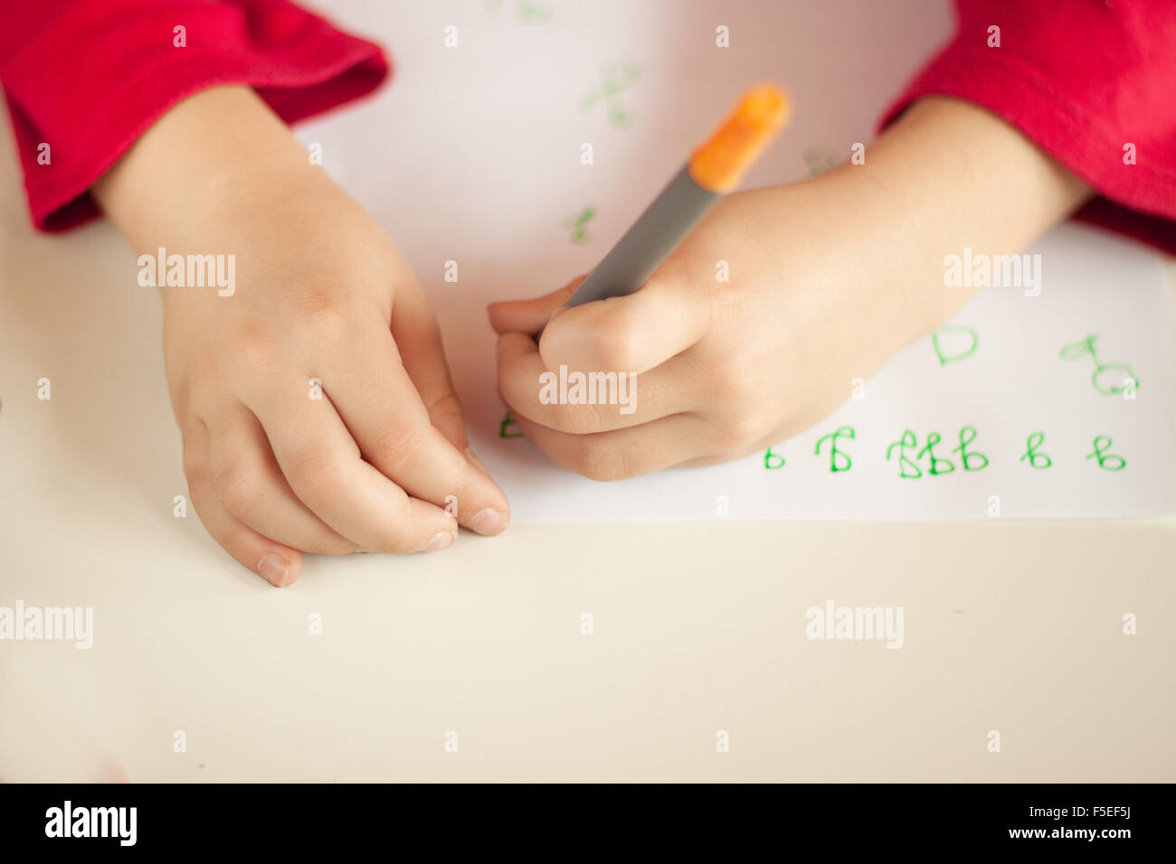 Girl learning to write Stock Photo - Alamy