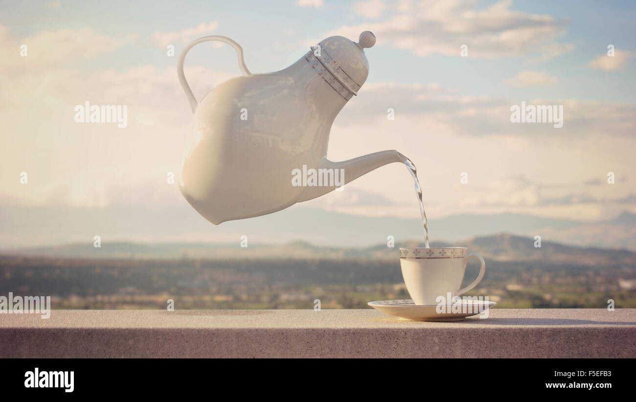 Conceptual floating teapot pouring tea into a cup Stock Photo - Alamy