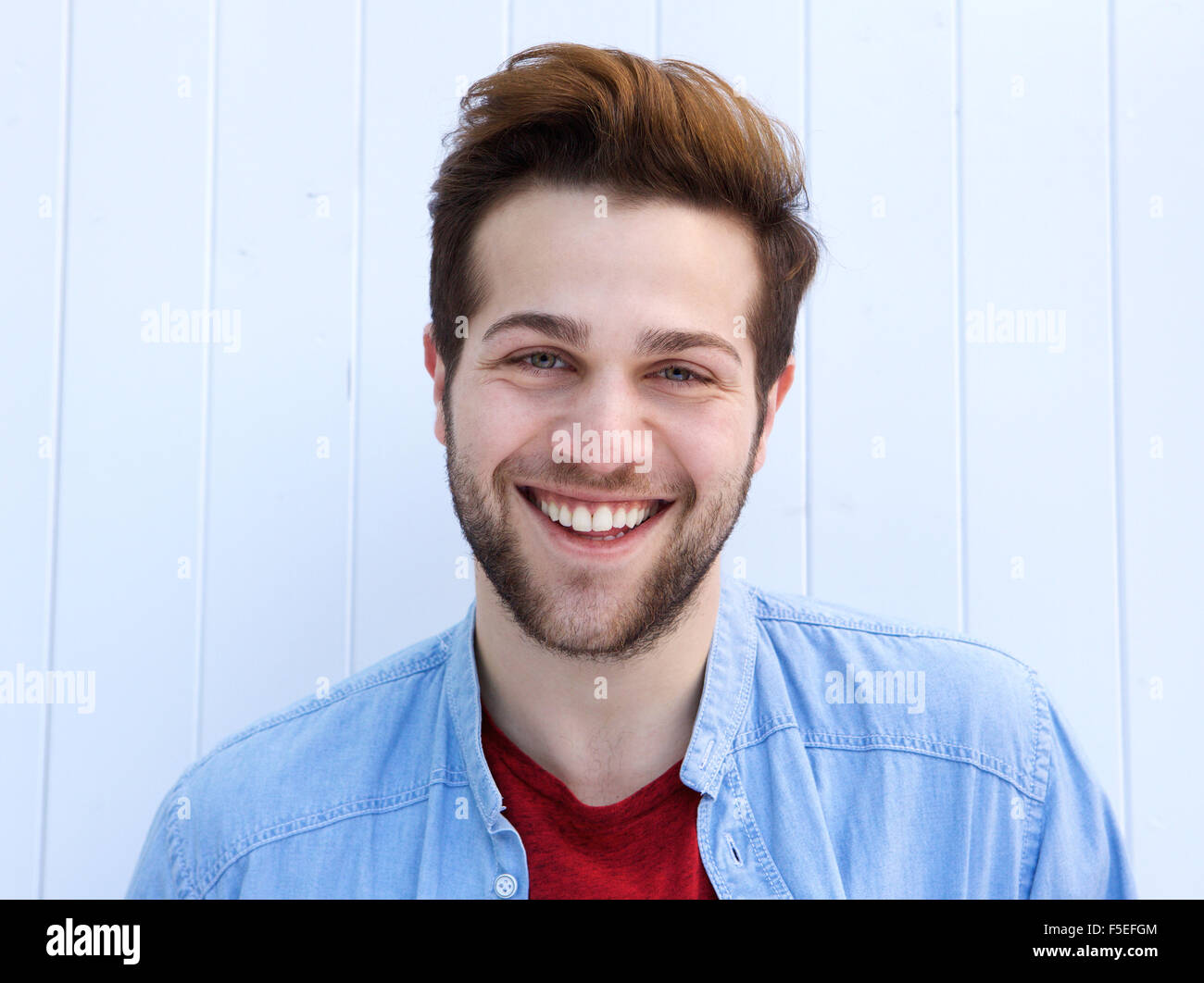 Portrait of a cool guy smiling against white background Stock Photo - Alamy
