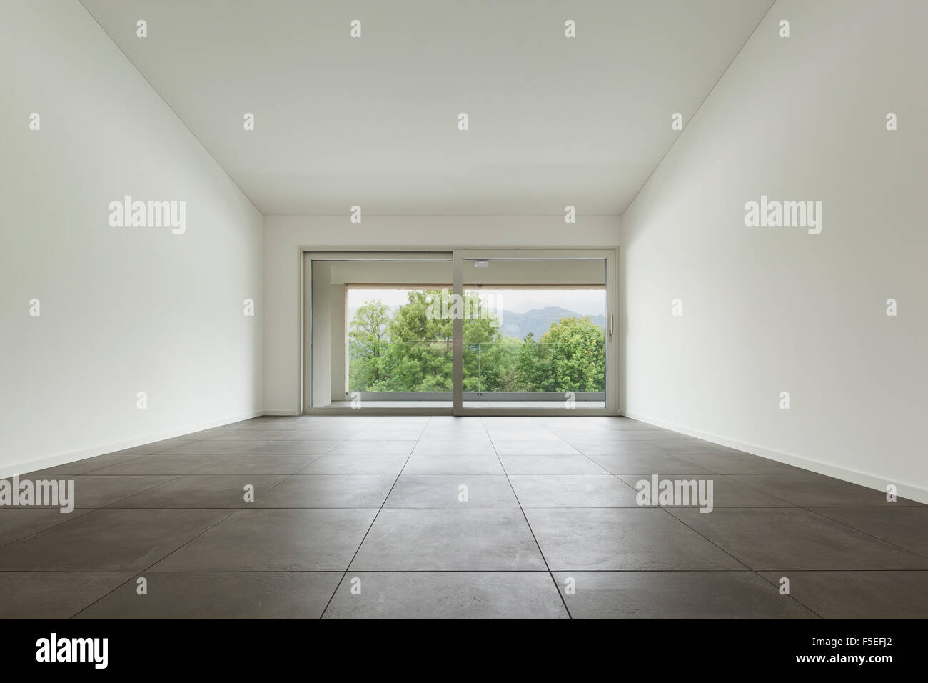 interior of new apartment, wide room with window, tiled floor Stock ...