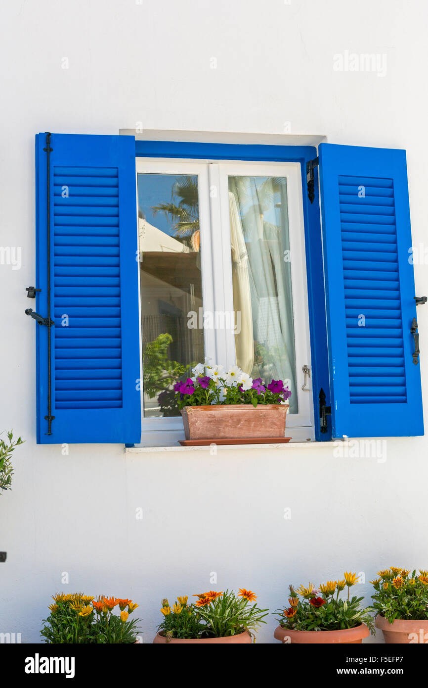 House with blue shutters decorated with fresh flowers Stock Photo - Alamy