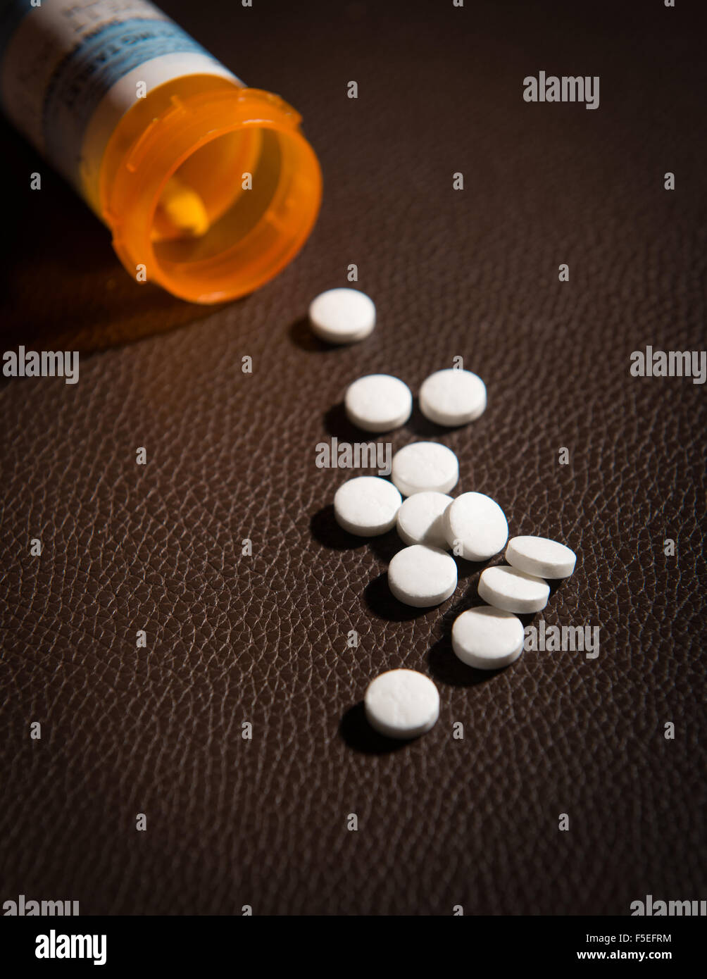 Prescription medication spilling out of a bottle Stock Photo - Alamy