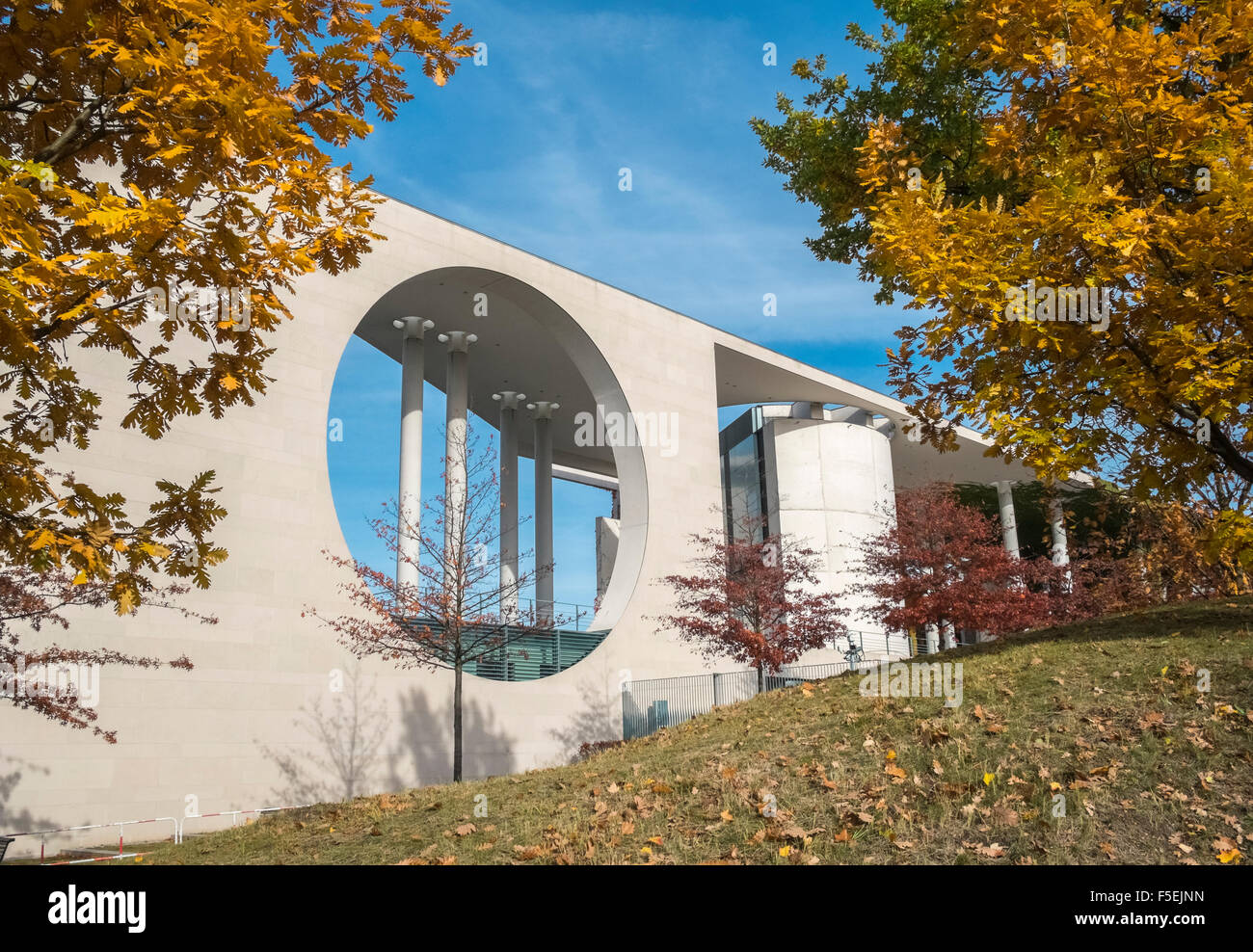 Modernist architecture of the Chancellery building surrounded by trees ...