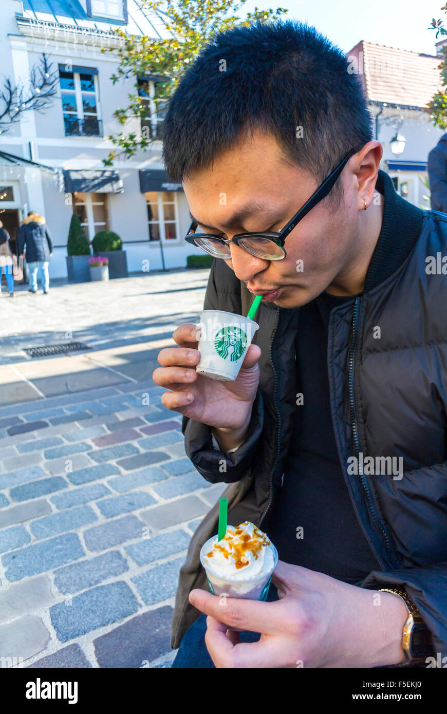 Paris, France, Chinese Man Eating Ice Cream on Street in "La Vallee ...