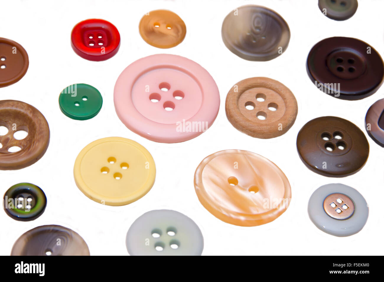 Colored buttons on a white background seen up close Stock Photo - Alamy