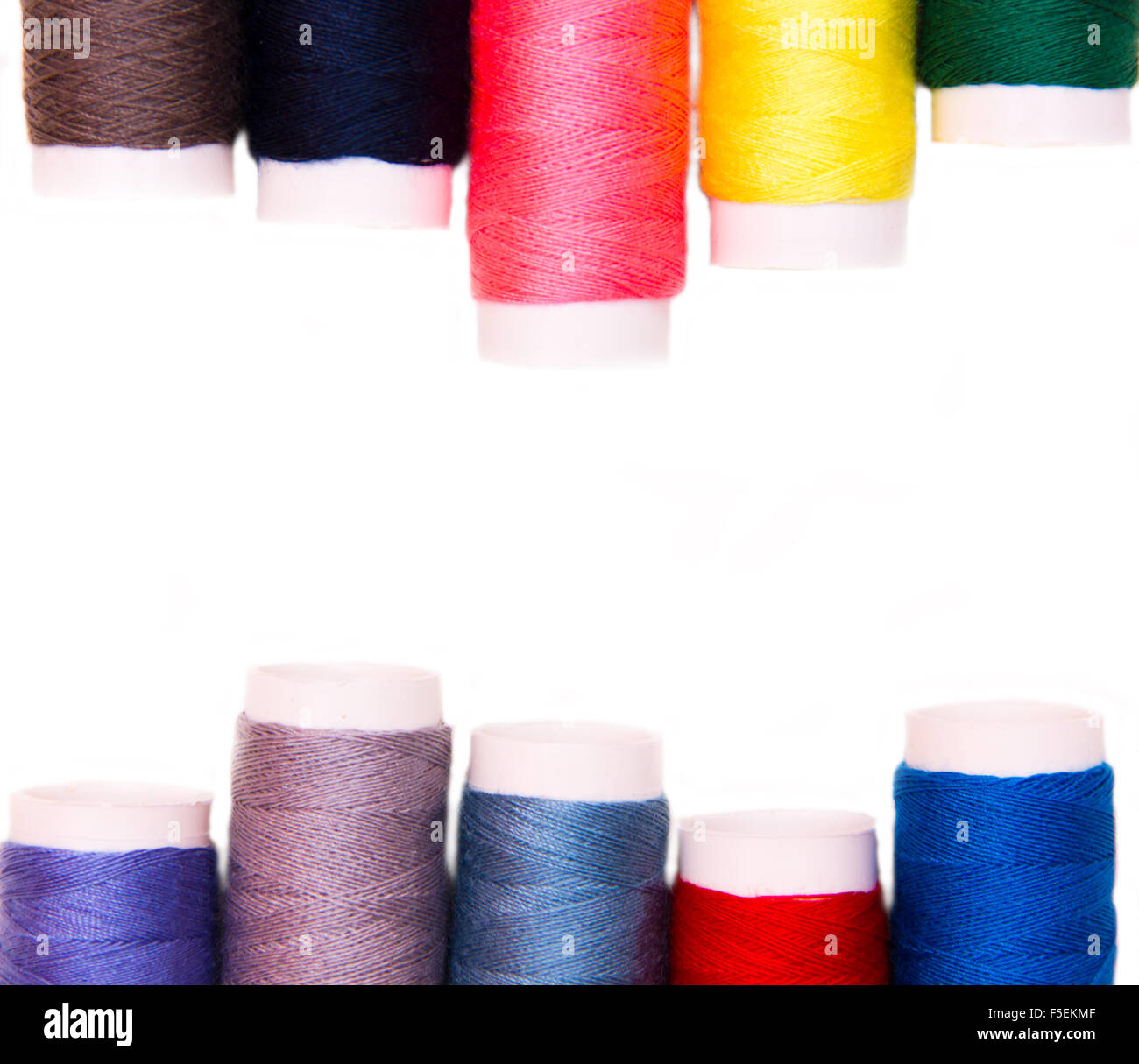 File in the top and bottom of sewing thread in different colors on ...