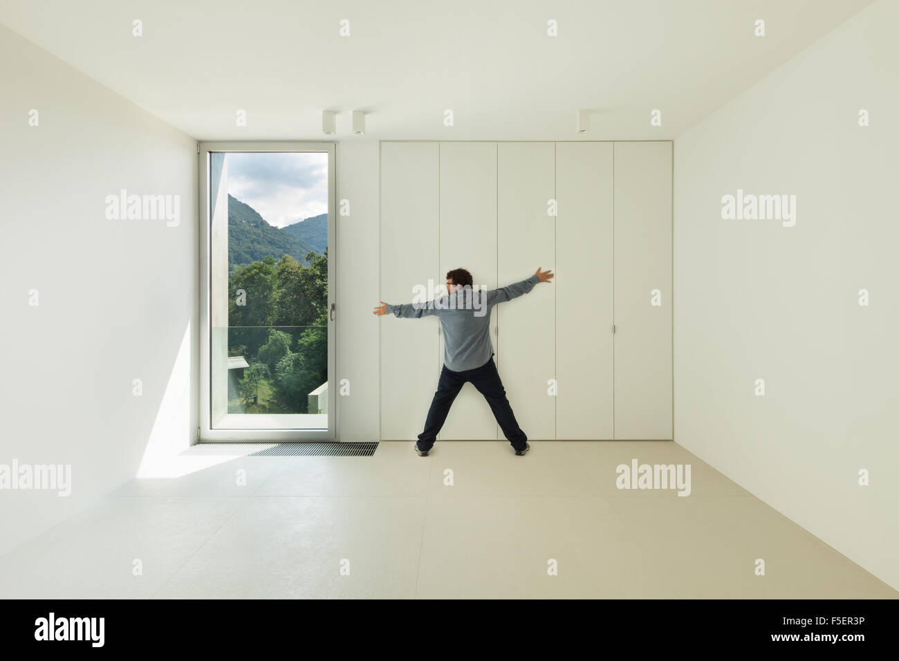 Architecture, new house interior, room with a man inside Stock Photo ...