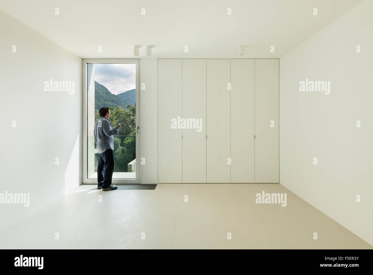 Architecture, new house interior, room with a man inside Stock Photo ...
