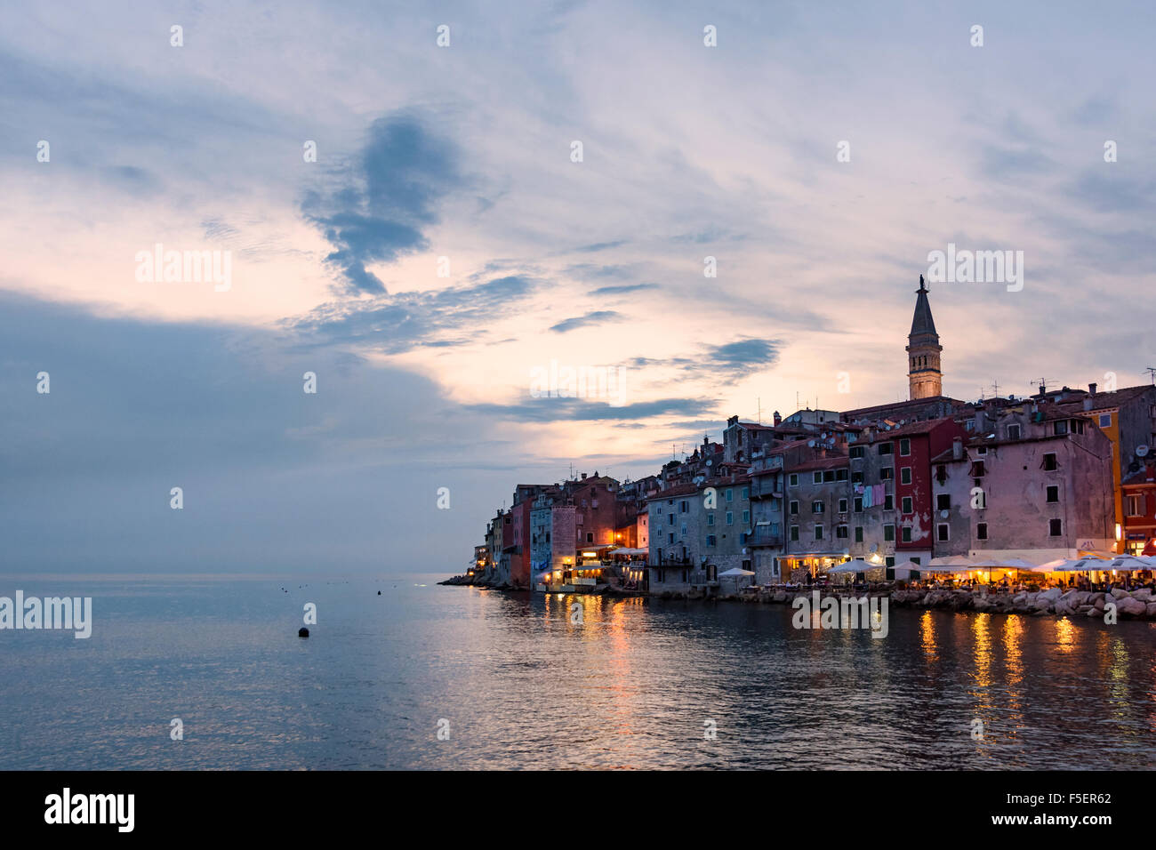 Sunset over the colourful old buildings on the peninsular of Old Rovinj ...