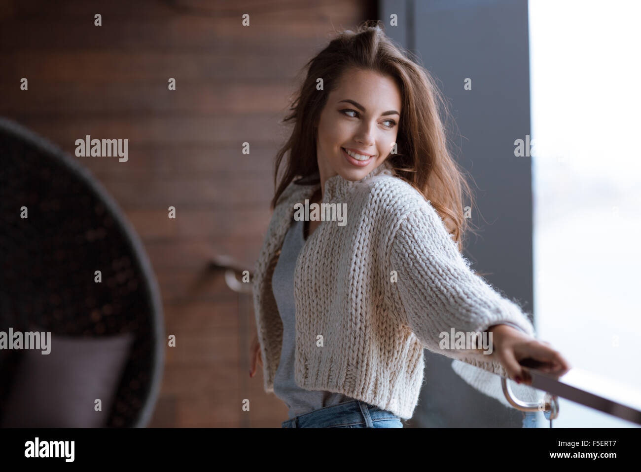 Portrait of a happy woman looking in window Stock Photo - Alamy