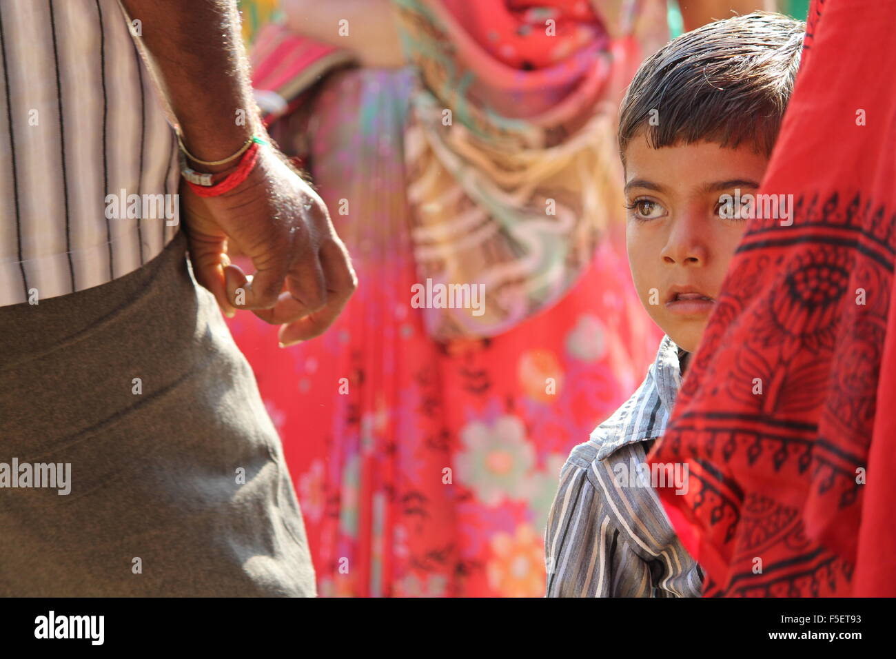 Hidden boy searching with innocent eyes Stock Photo - Alamy