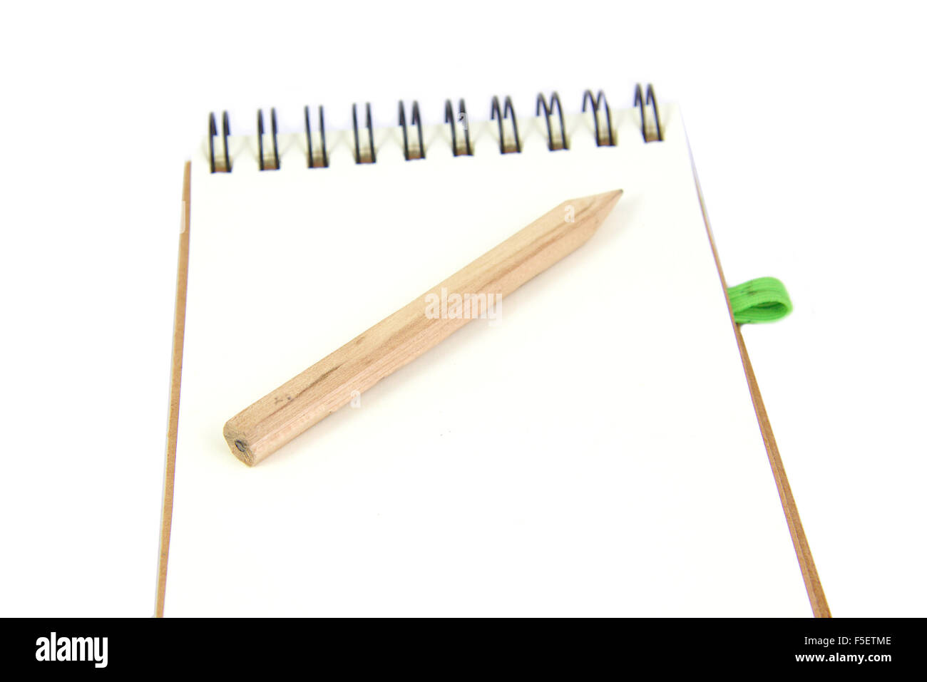 Pencil on notebook in a white background Stock Photo - Alamy