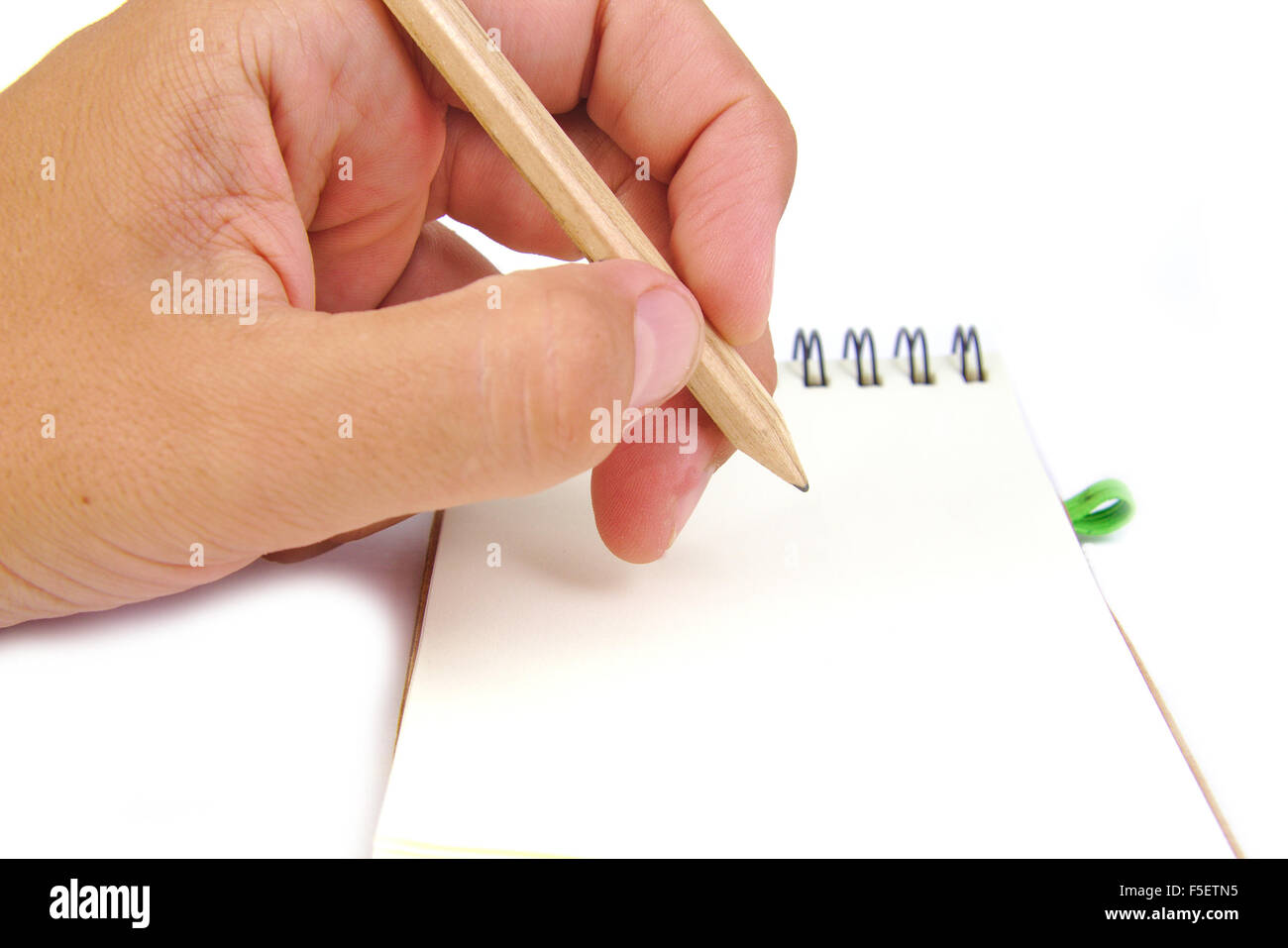 Hand with pencil take notes in a notebook on a white background Stock ...
