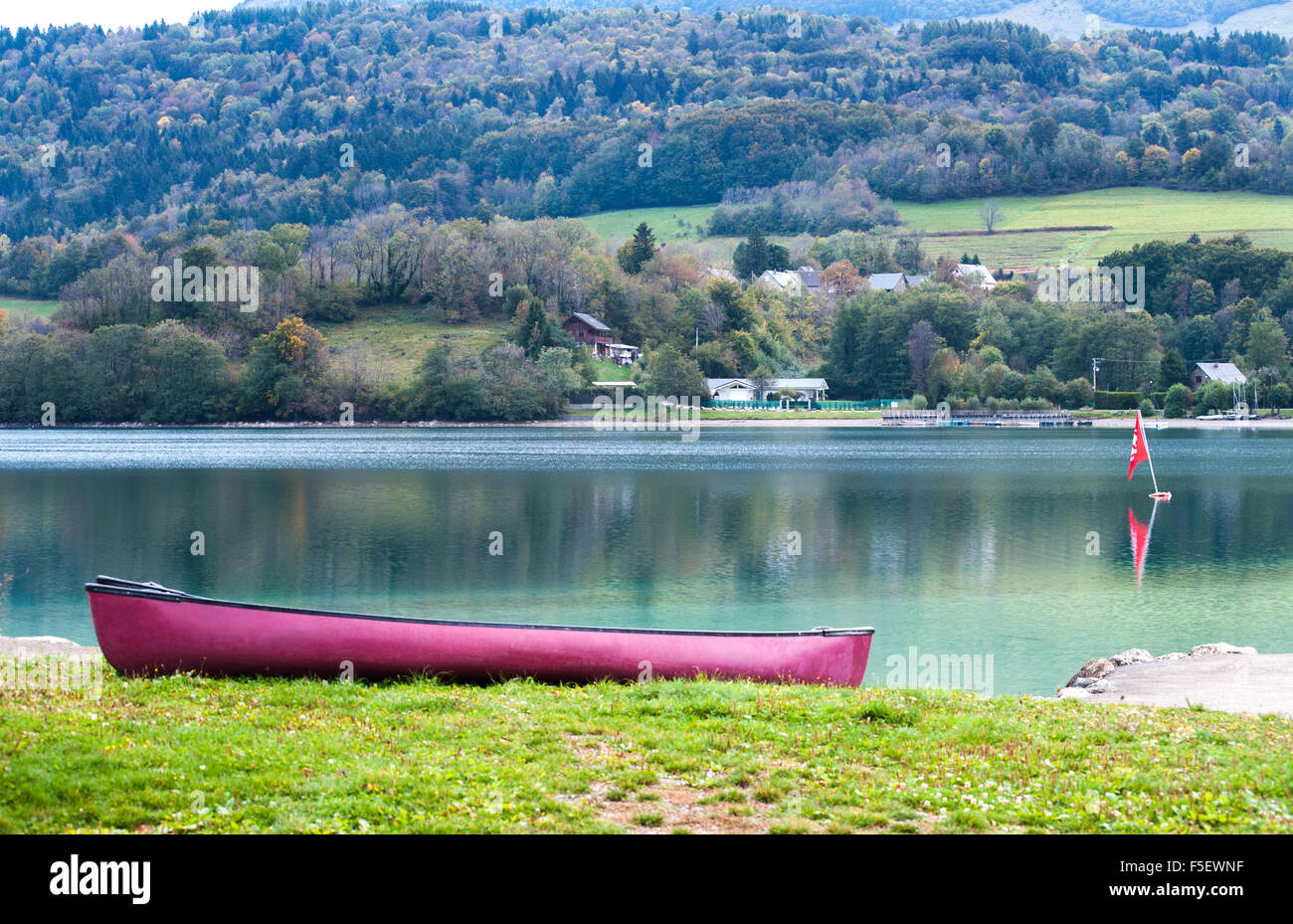 Red canoes on the Grand lac de Laffrey is one of the Laffrey lakes ...