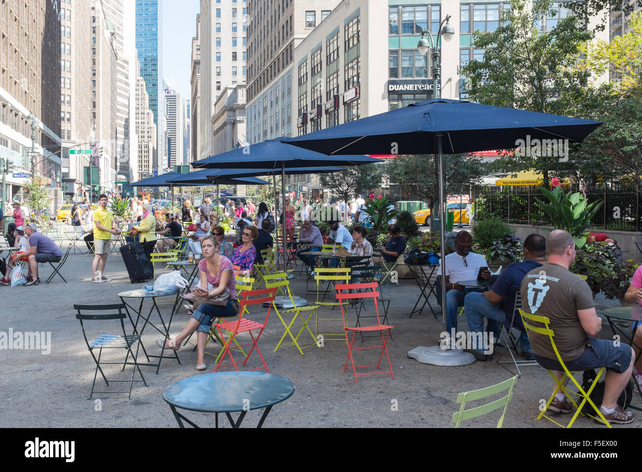 Colourful tables and chairs in a pedestrian area in Manhattan, New York ...