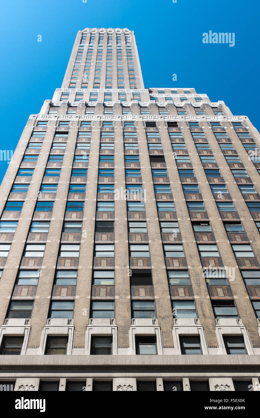 Looking up at tall sky scrapers against a blue sky in Manhattan, New ...