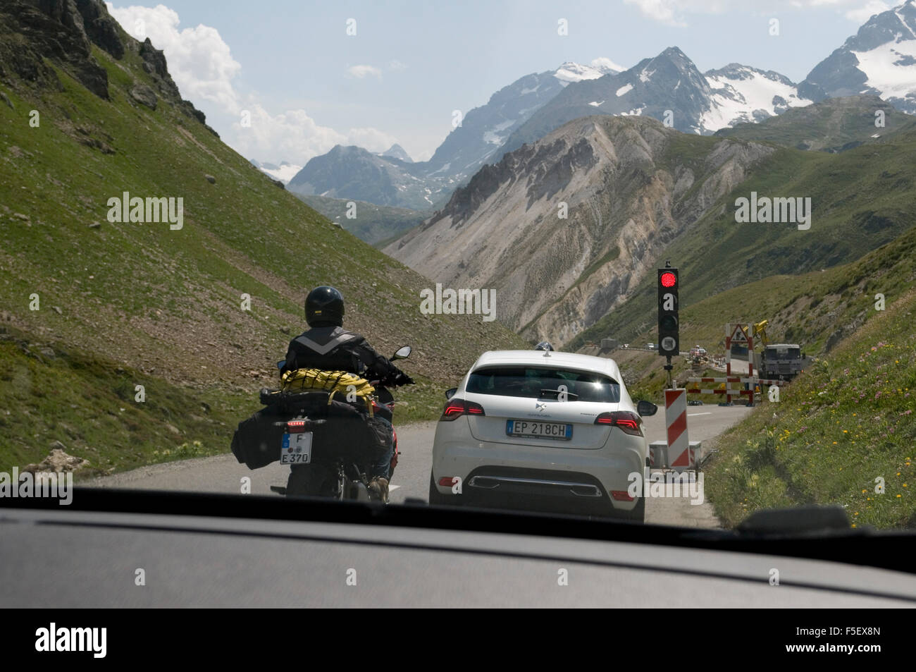portable red traffic light on mountain road, Graubunden, Swiss alps ...
