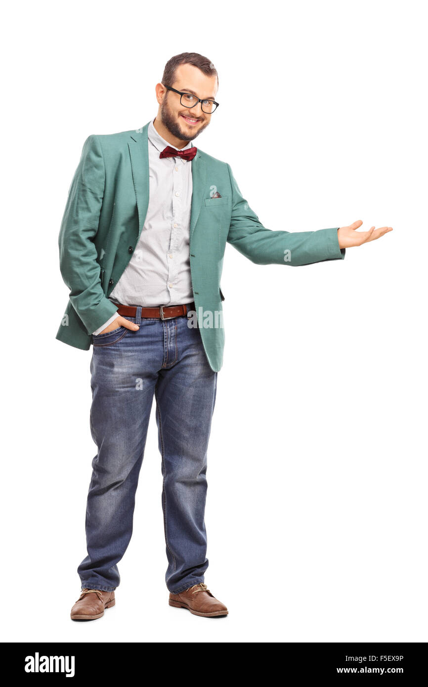 Full length portrait of a fashionable guy gesturing with his hand and ...