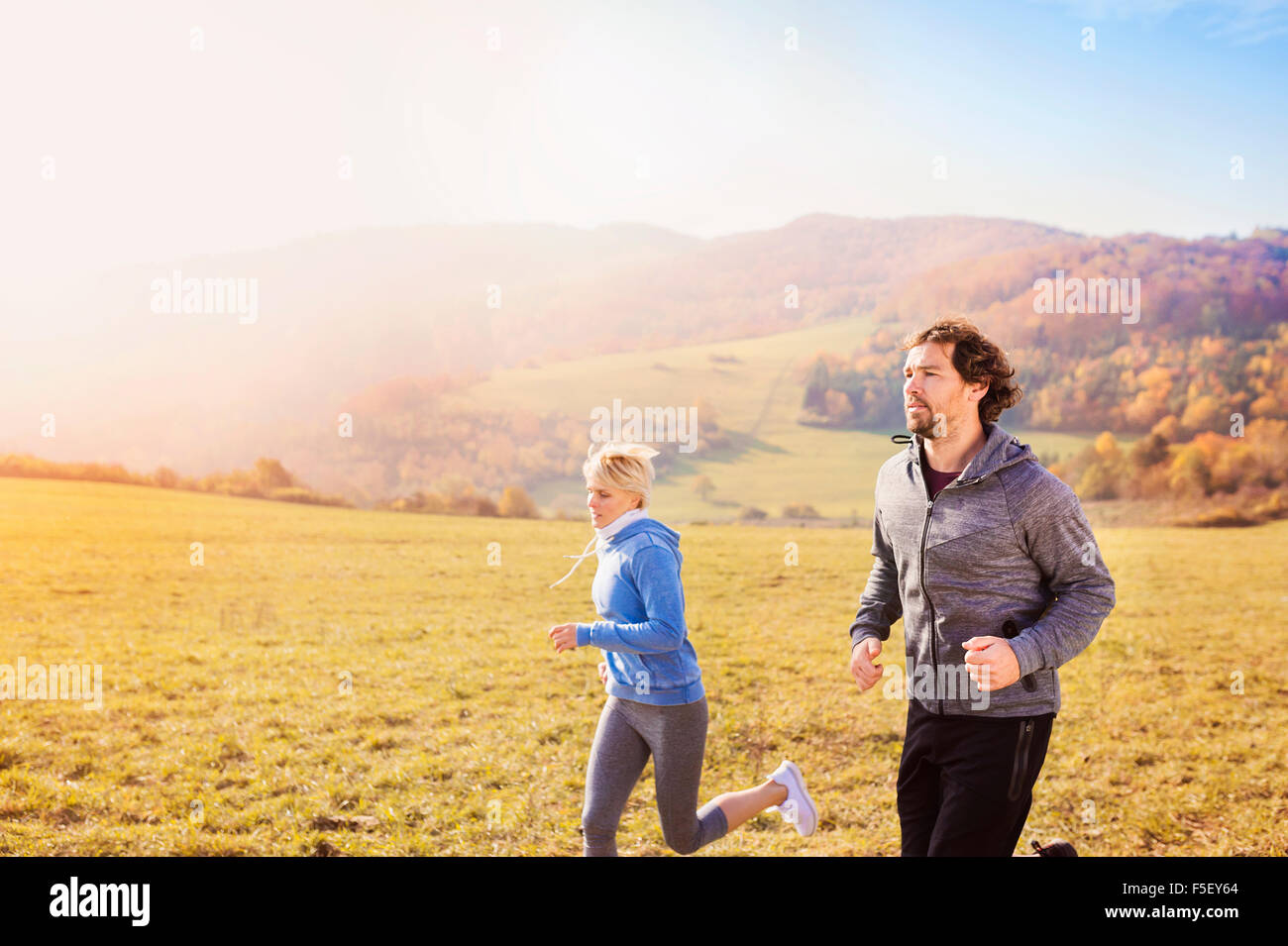 Beautiful couple running Stock Photo - Alamy