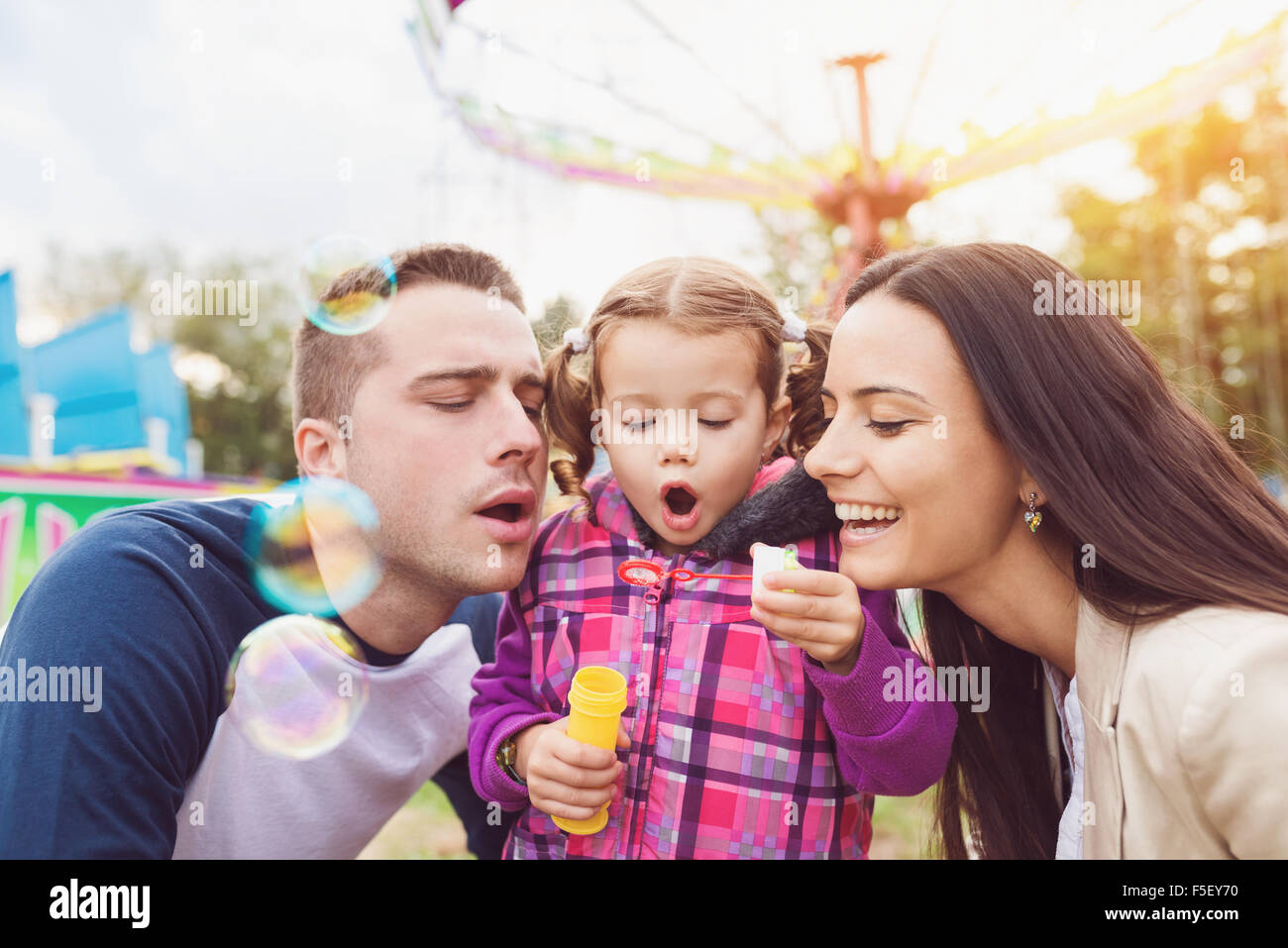 Family at fun fair Stock Photo - Alamy