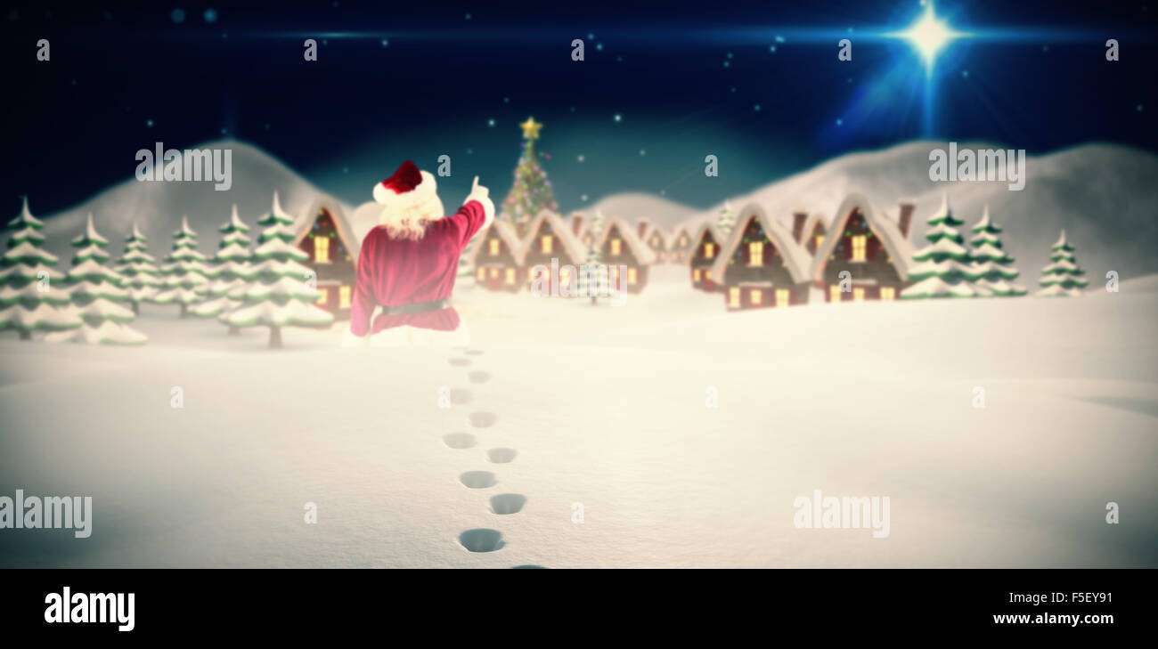 Composite image of santa claus points at something Stock Photo - Alamy
