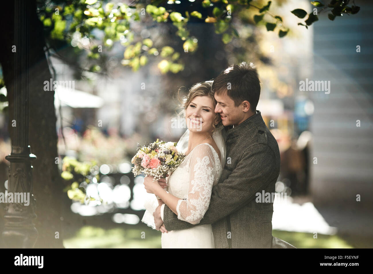Groom hugs bride Stock Photo - Alamy