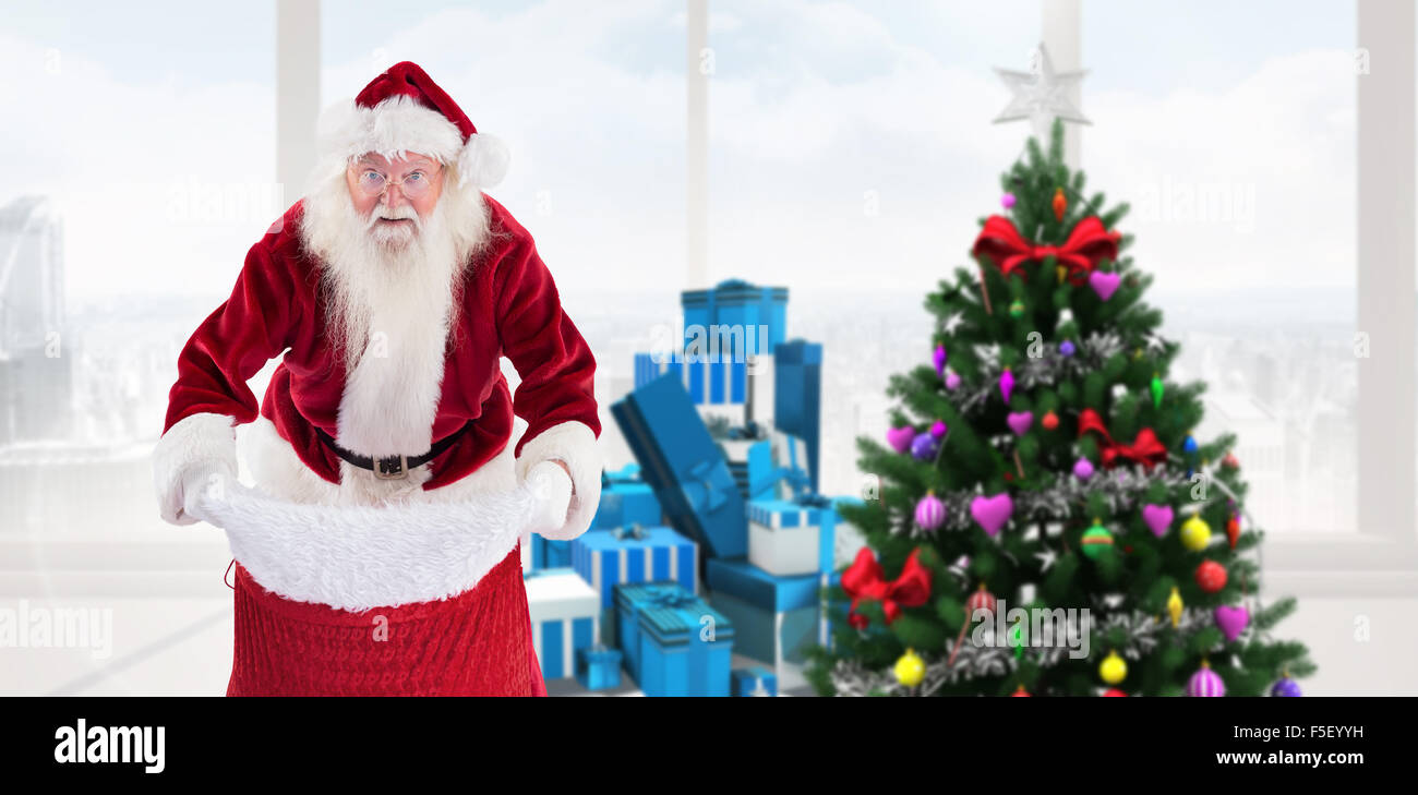 Composite image of santa open his red bag Stock Photo - Alamy