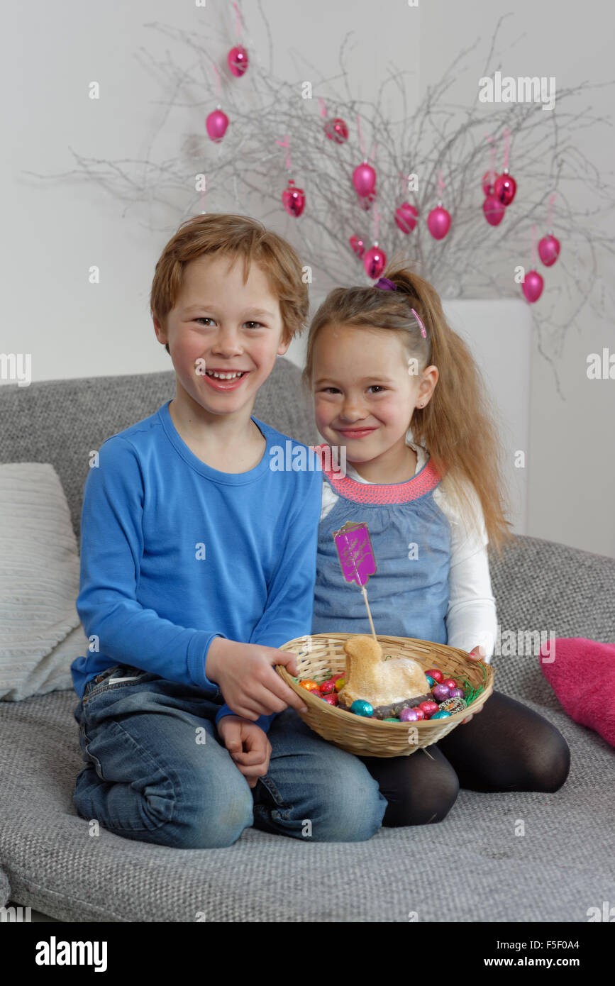 Children, boy and girl with Easter basket, nest and paschal lamb, Upper ...
