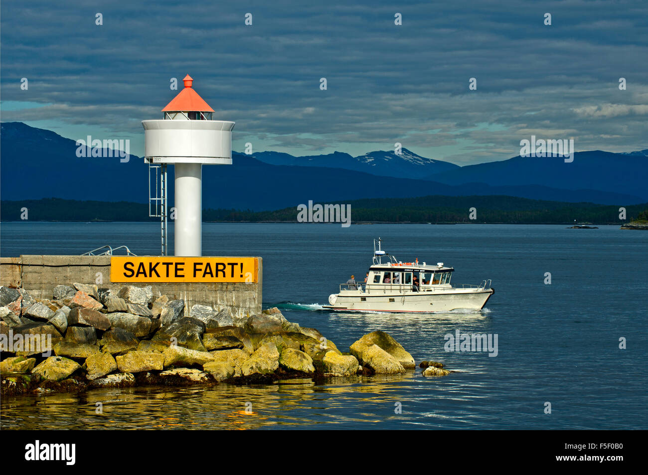 Motorboat at Molde lighthouse, harbour entrance, Molde, Norway Stock ...