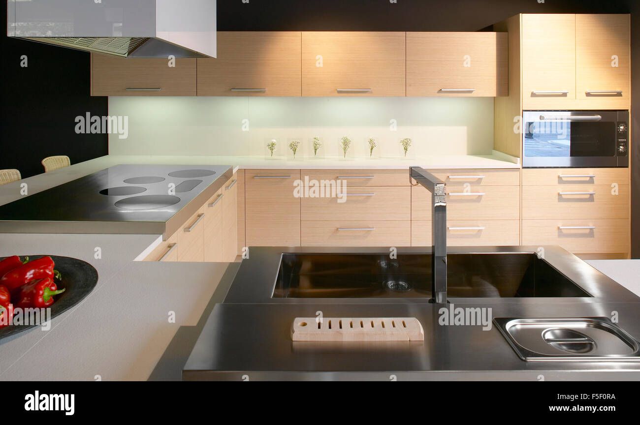 View of a domestic modern kitchen with cabinets, drawers and ceramic ...