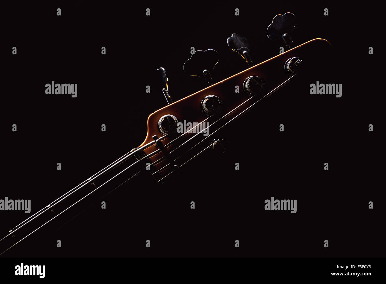 Part of a jazz bass guitar, accentuated shapes with illumination Stock ...