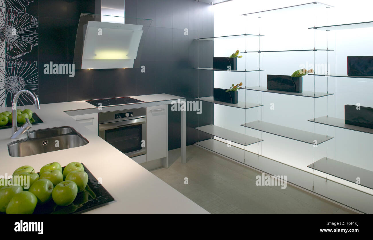 View of a domestic modern kitchen with cabinets, drawers and ceramic ...