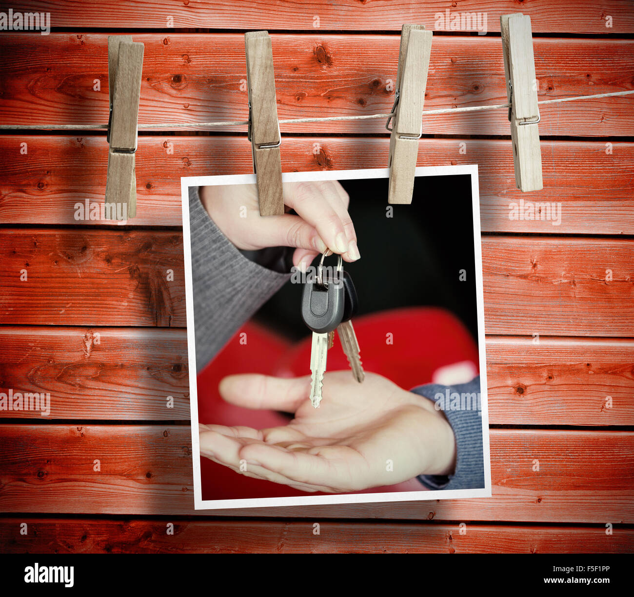 Composite image of photo hanging from line Stock Photo - Alamy