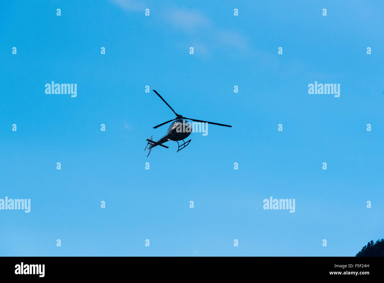landscape with helicopter over mountains with blue sky Stock Photo - Alamy