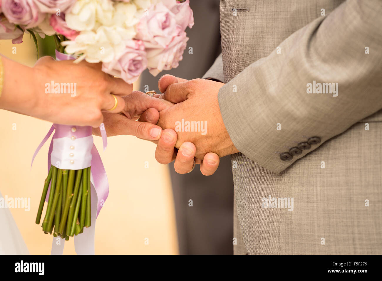 Couple holding hands during wedding ceremony Stock Photo - Alamy