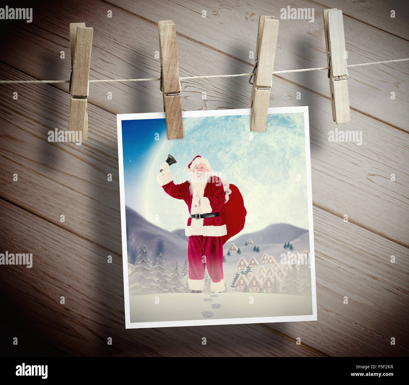 Composite image of photo hanging from line Stock Photo - Alamy