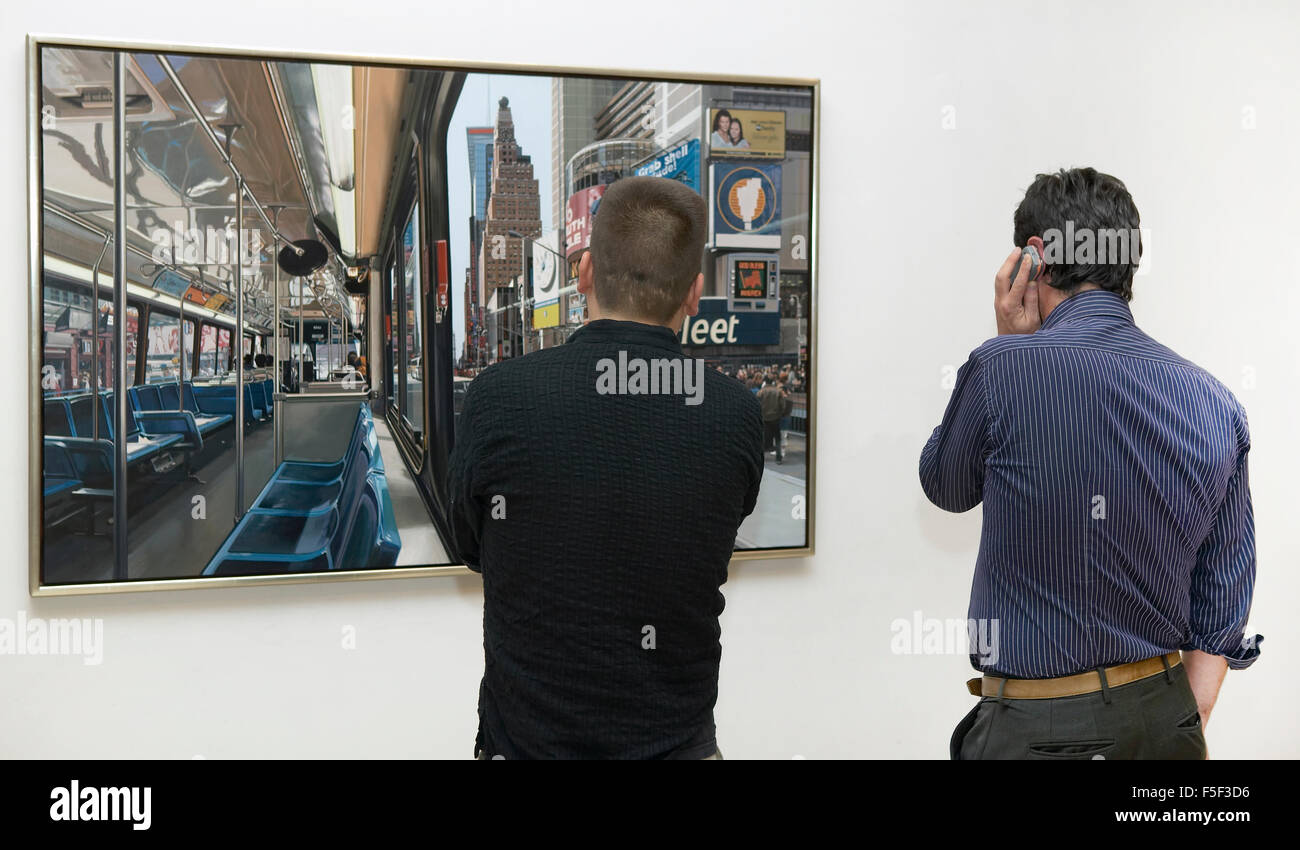 Young men inside a museum in front of a picture looking at it Stock ...