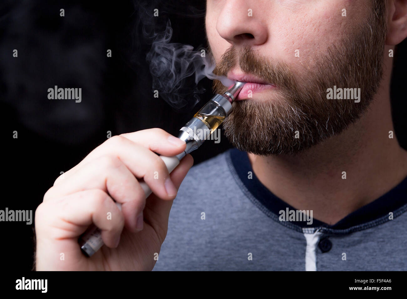 smoking electric cigarettes on the black background Stock Photo - Alamy