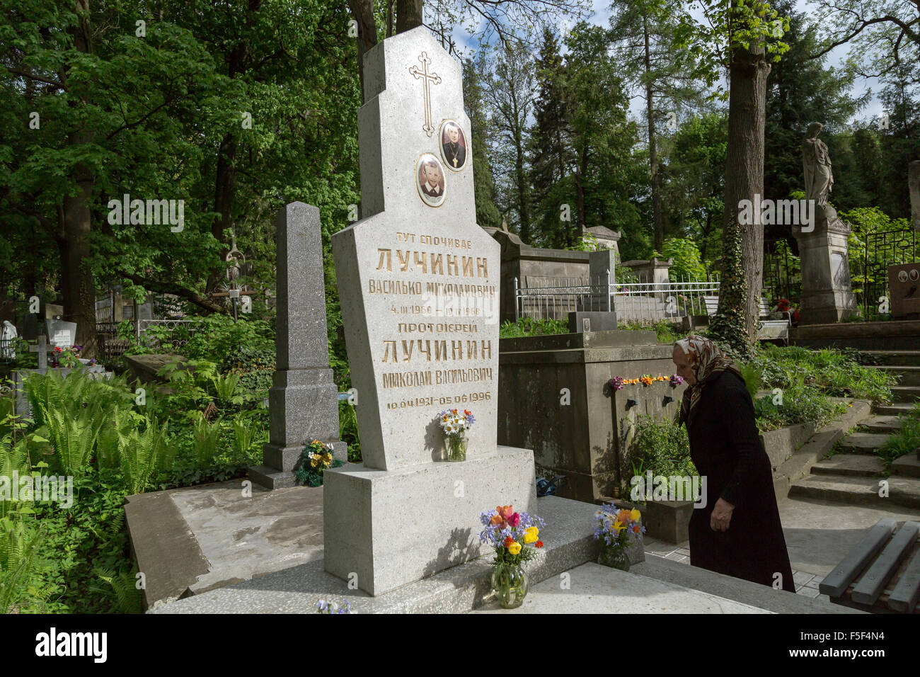 Lviv, Ukraine, working on a Ukrainian orthodox grave at the Lychakiv ...