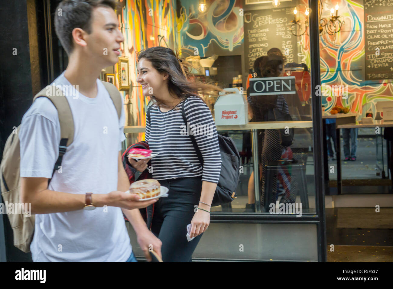 Doughnut lovers leave the grand opening of The Doughnut Project, a new ...