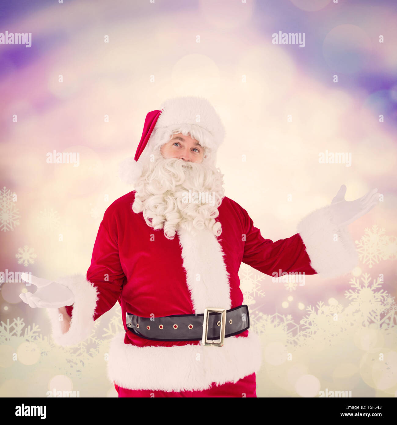 Composite image of father christmas with his hands out Stock Photo - Alamy