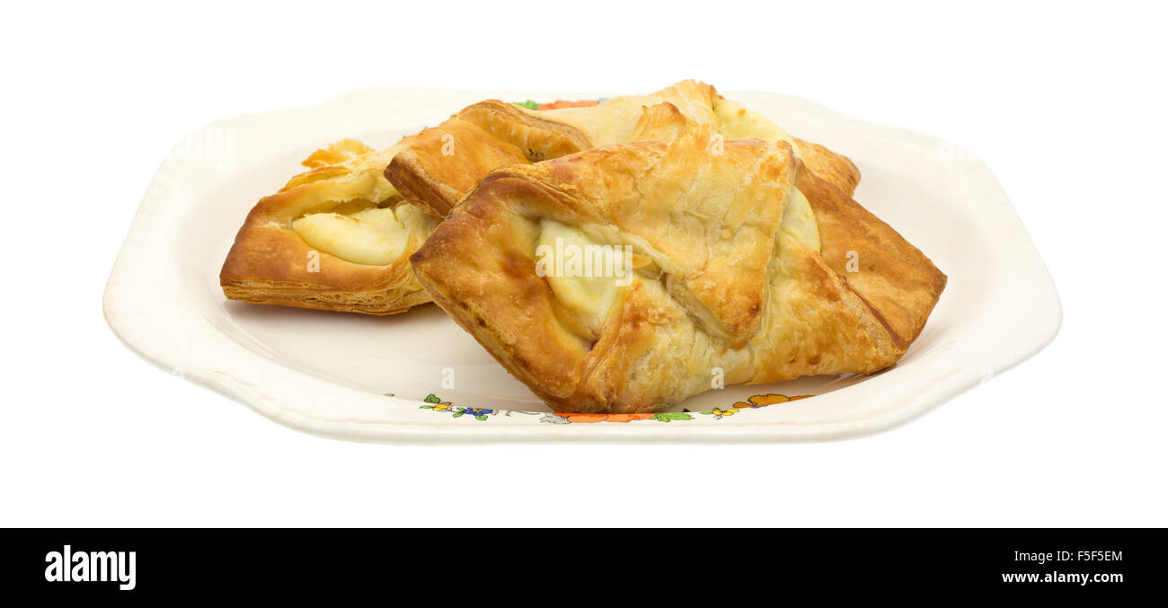 Side view of cheese danish pastries on an old serving dish isolated on ...