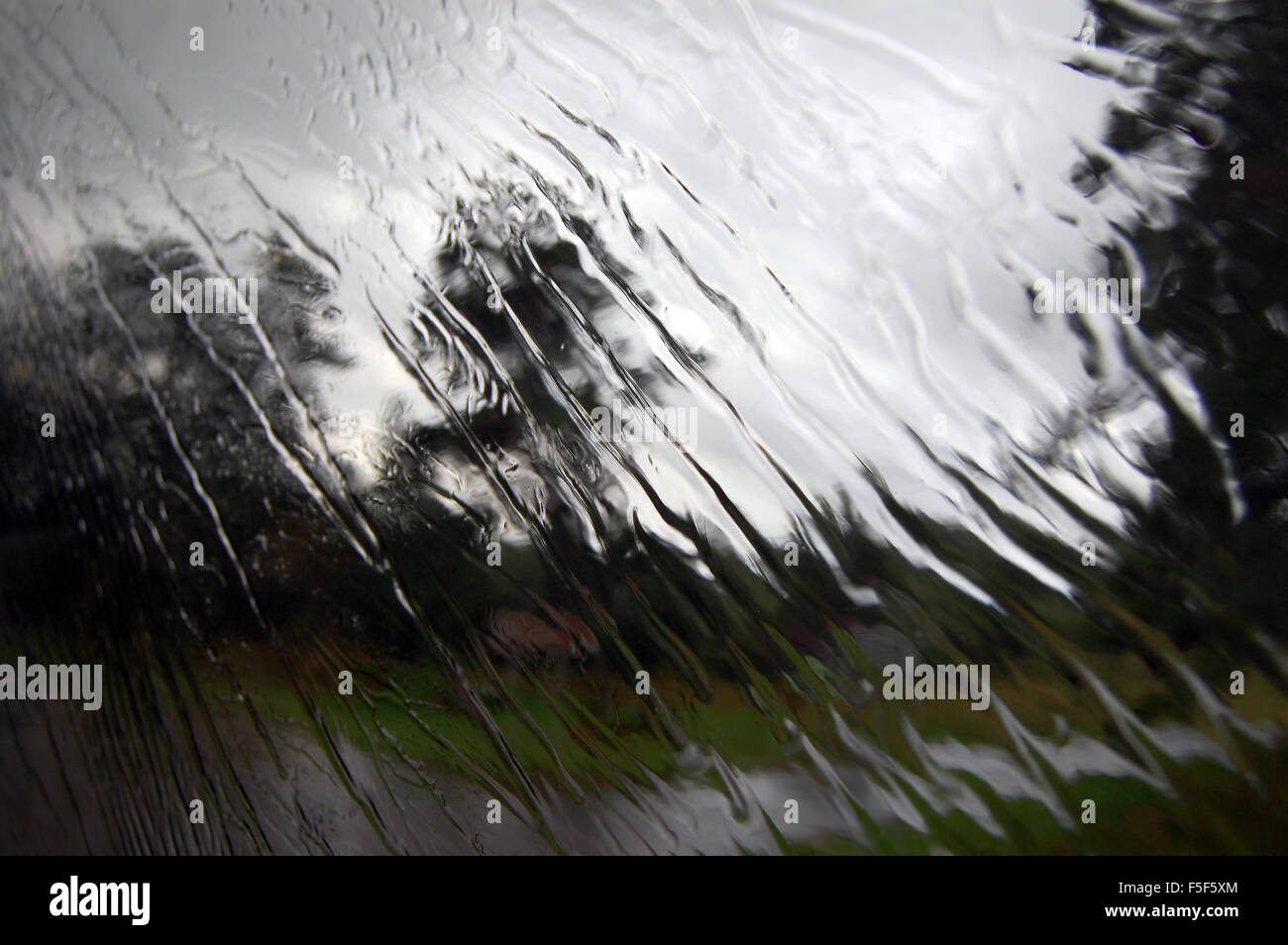 Heavy rain is falling under the window glass Stock Photo - Alamy